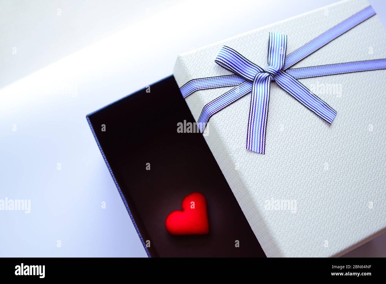 Top view of an open blue and white gift box or present box package with ...