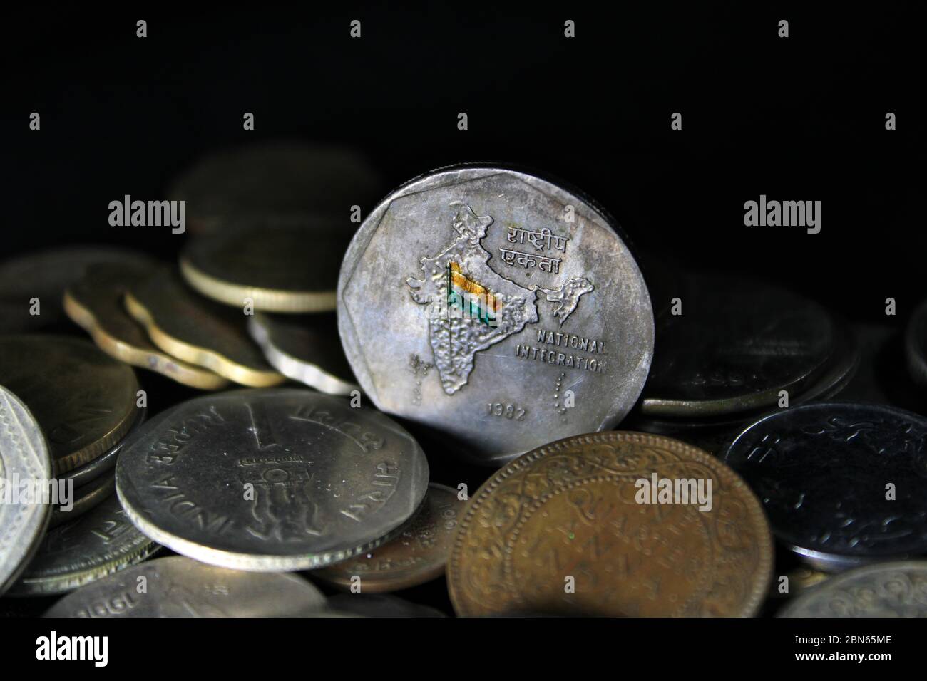 Two rupee coin of India isolated on black background. Map of India as a ...
