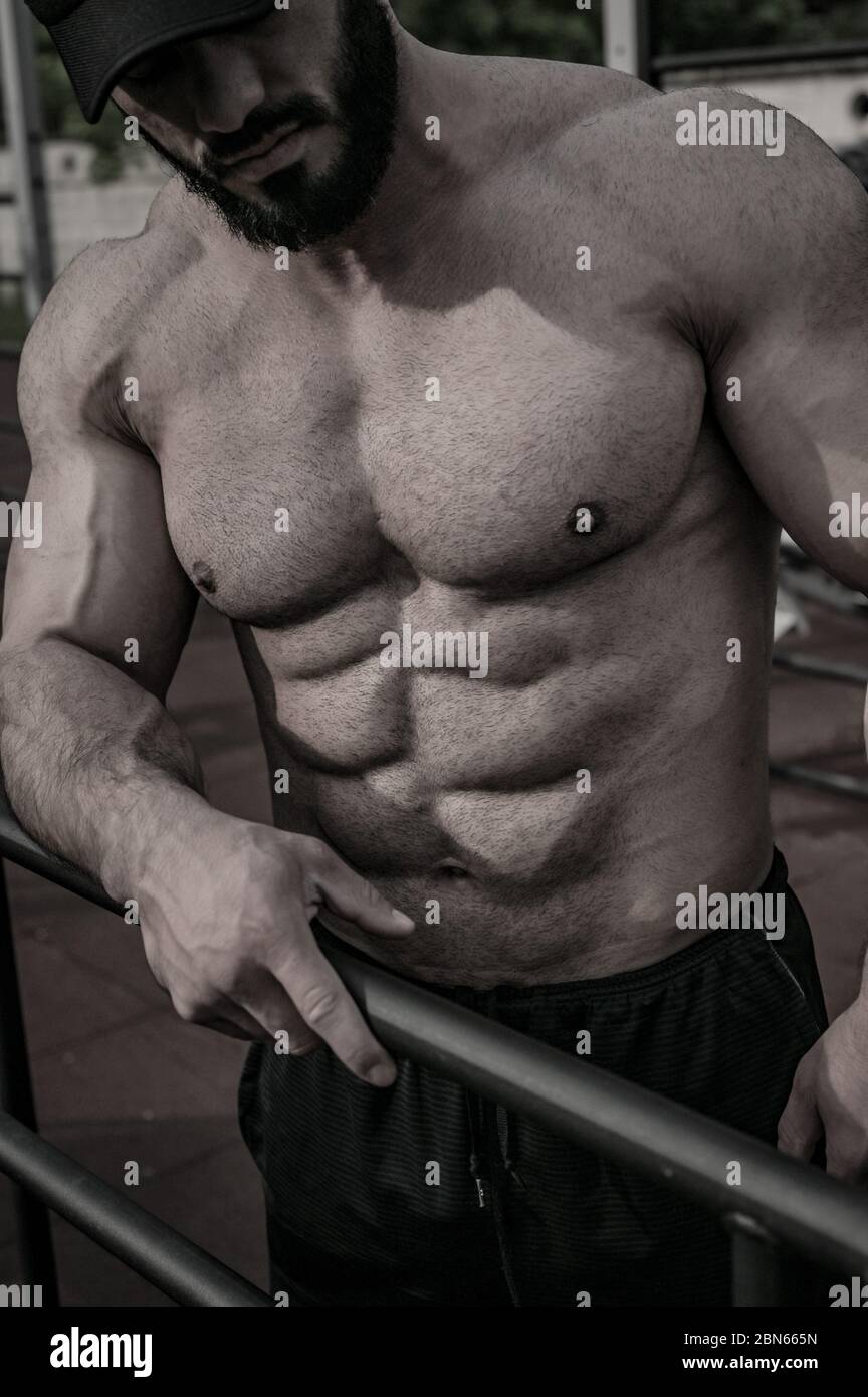 strong young man athlete with beard with perfect sport healthy body ...