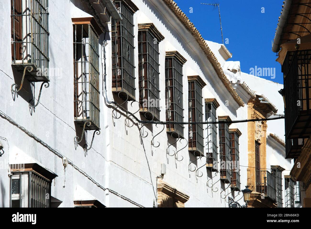 Traditional townhouses with ornate wrought iron window grills, Osuna ...
