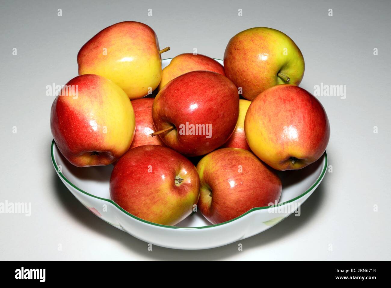 Jazz apples in a white ceramic bowl, UK Stock Photo - Alamy
