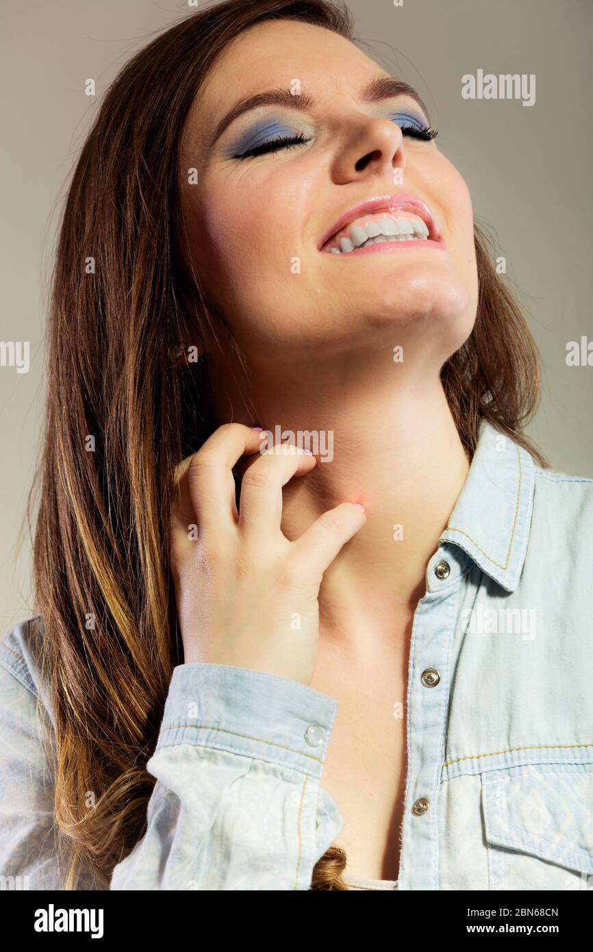 Health problem. Young woman scratching her itchy nack with allergy rash ...