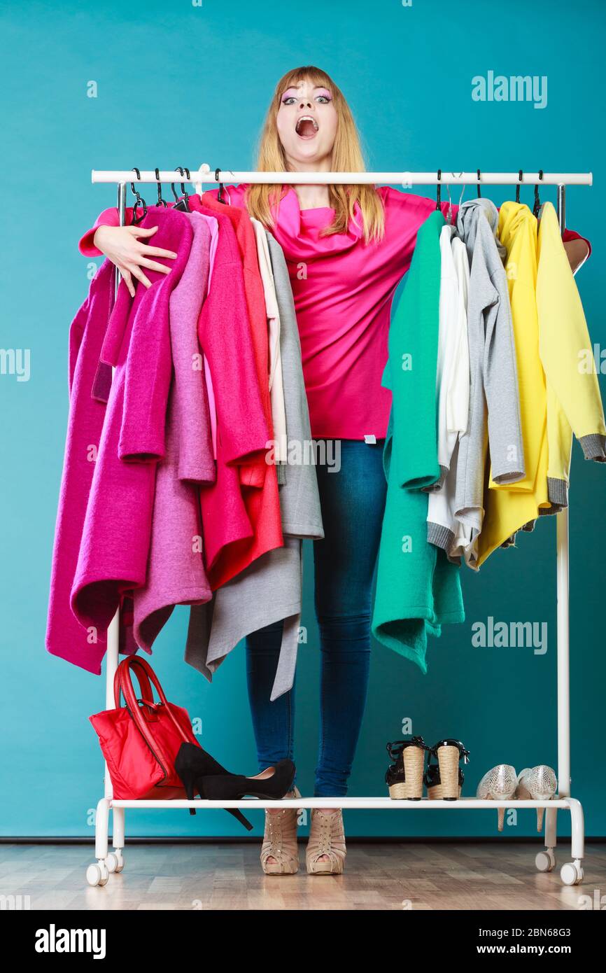 Funny woman girl taking grabbing all clothes coats and shirts in ...