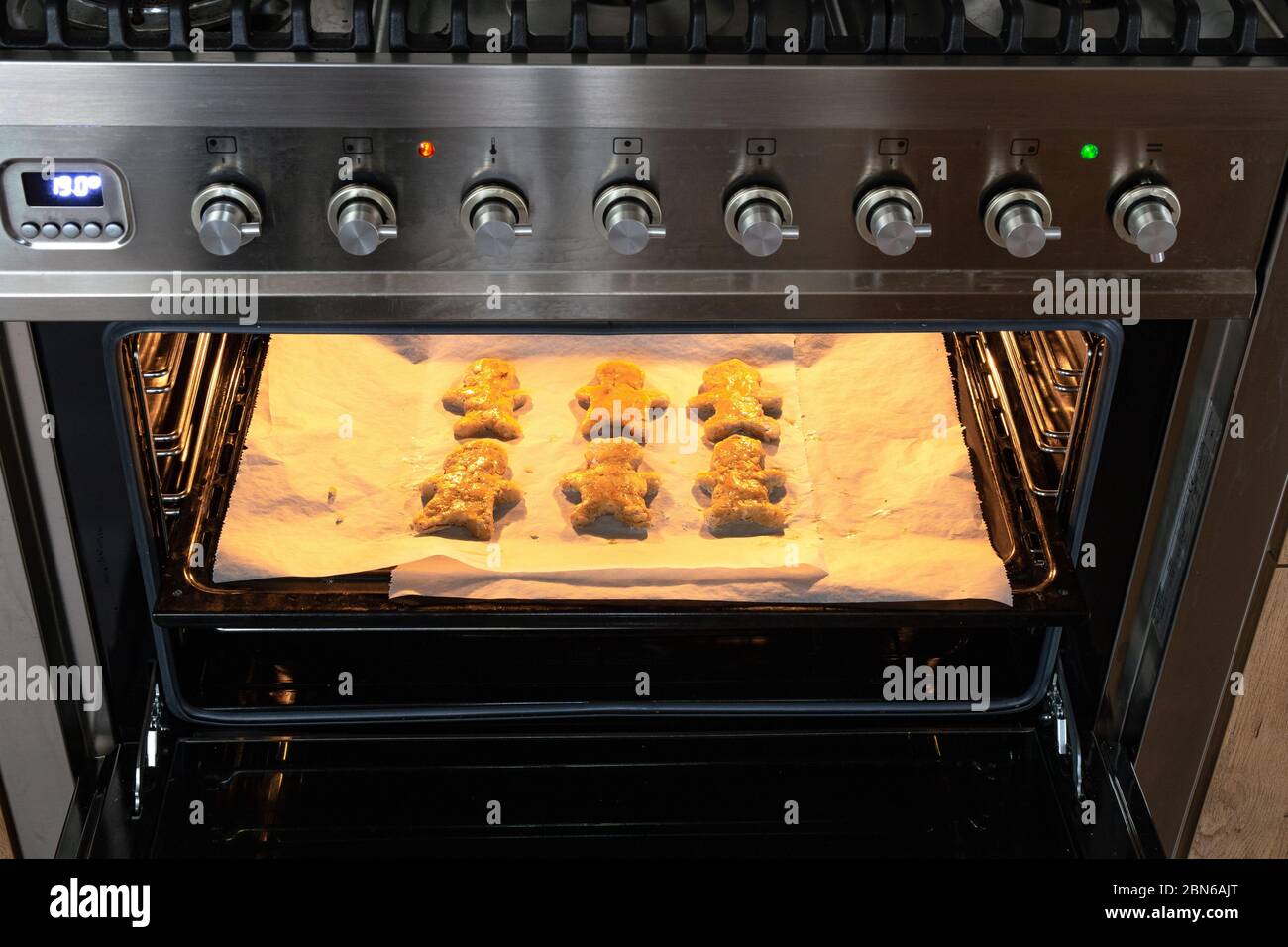 Baking Gingerbread man in the oven, Woman making homemade gingerbread ...