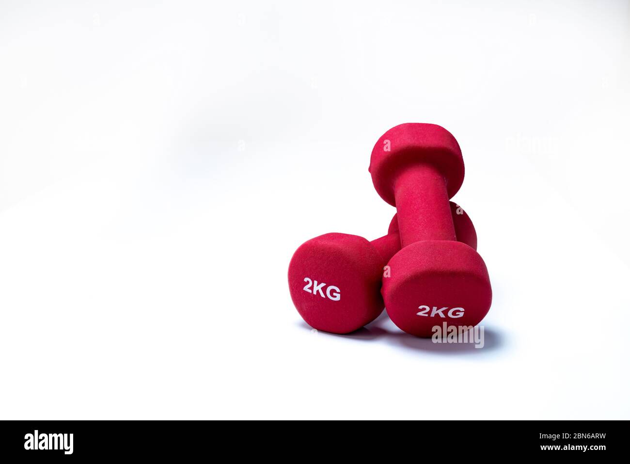 Set of red dumbbells isolated on white background. A pair of red ...