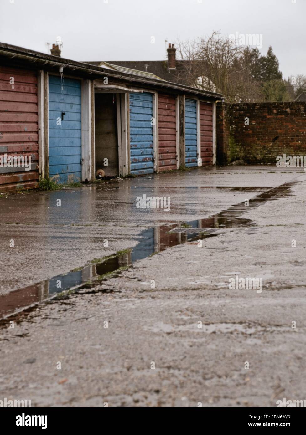 Back street lock-up garages in the rain in Buckinghamshire Stock Photo ...