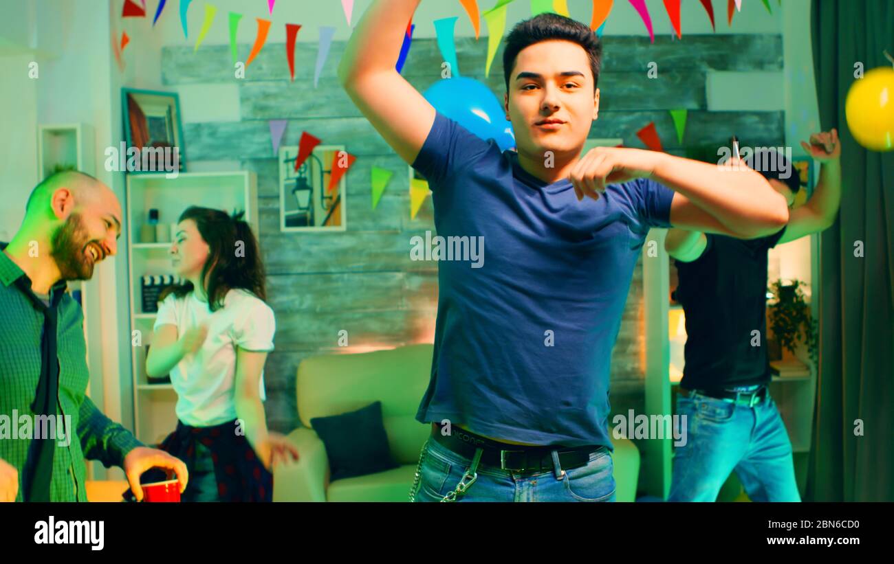 Excited young man partying with his friends. Attractive group of people ...