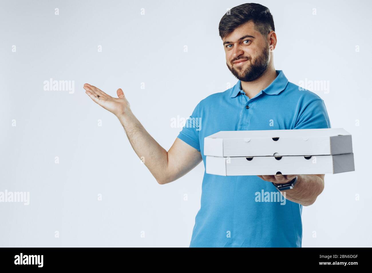 Food delivery courier with order on grey background Stock Photo - Alamy