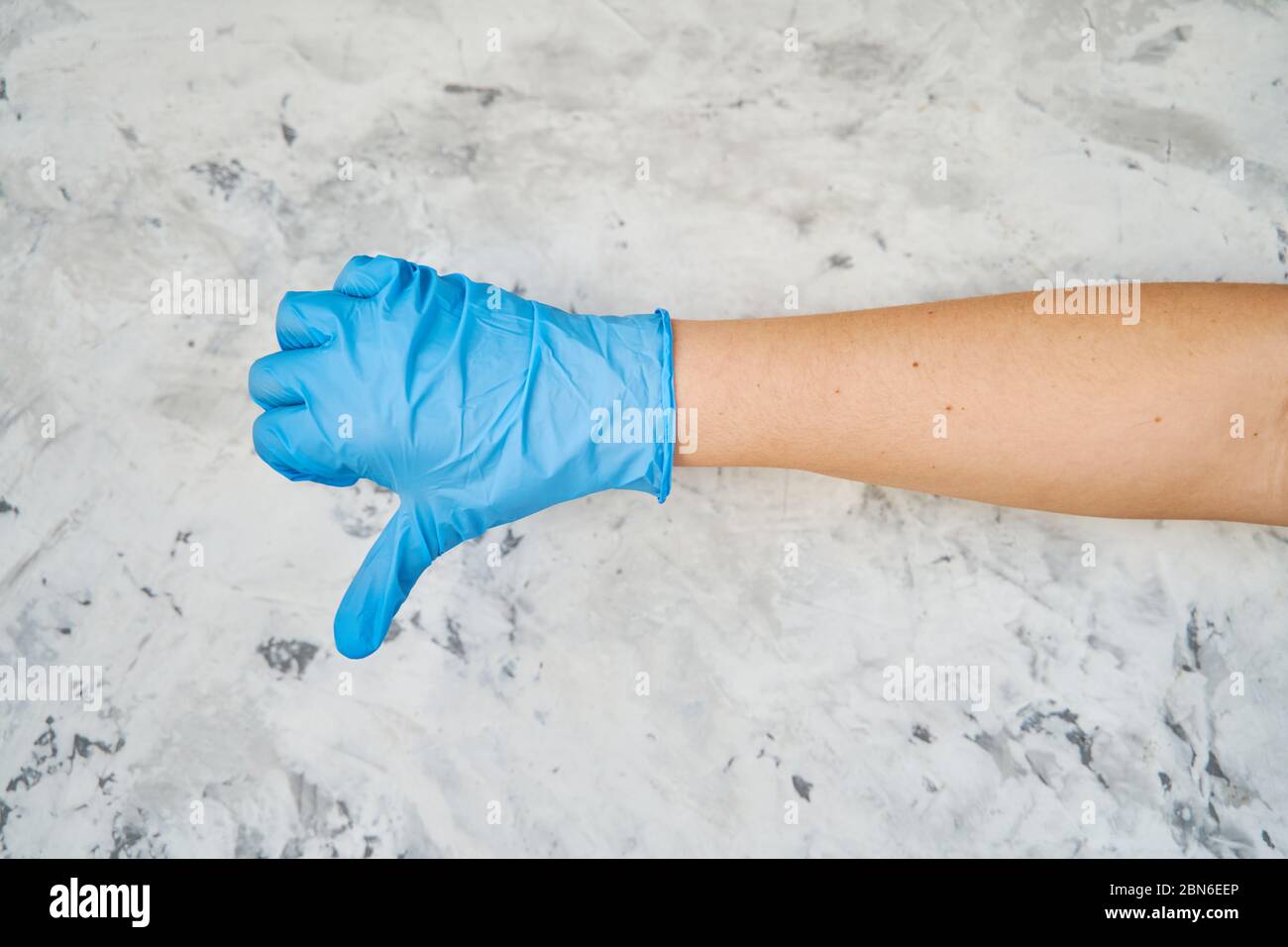a girl in a blue glove holds a sign in her hand Dislike Stock Photo - Alamy