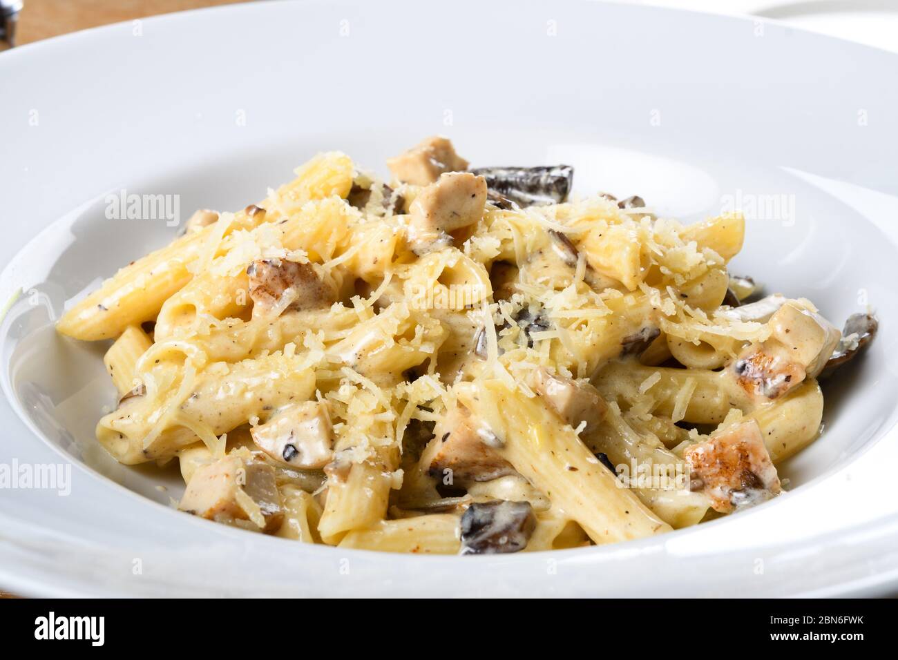 Traditional authentic italian penne al pollo e funghi pasta with ...