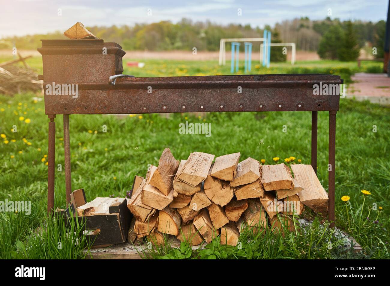 Barbecue for cooking meat on fire. With prepared logs for lighting a ...