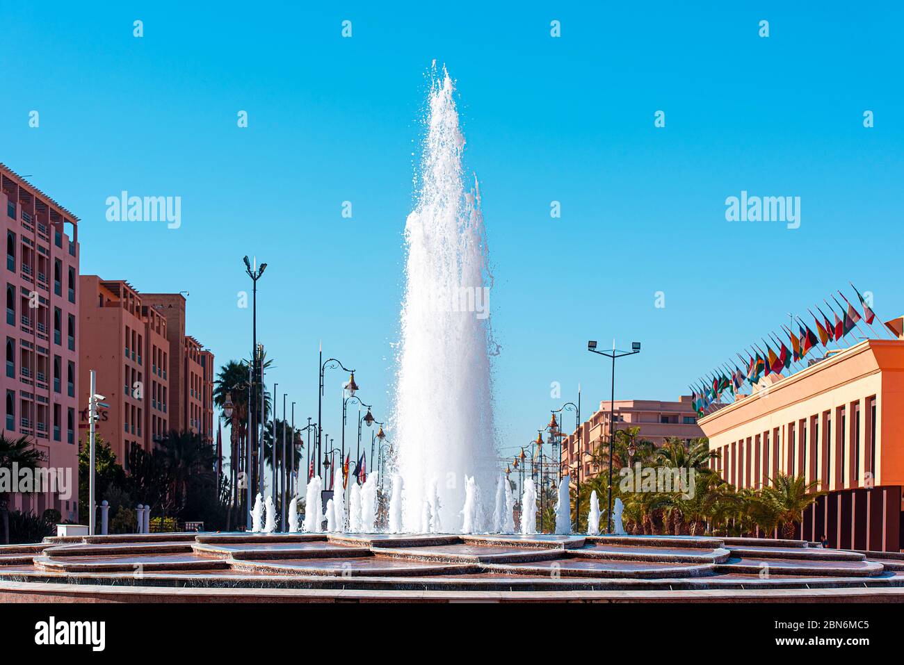 Marrakesh or Marrakech, modern street, part of city with tall fountain ...
