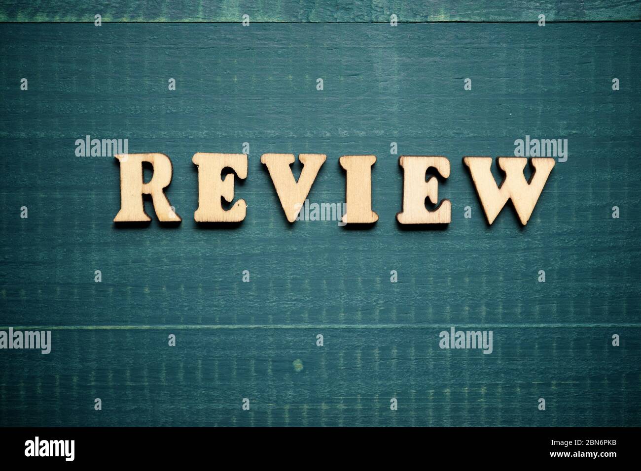 Review word on a wood table Stock Photo - Alamy