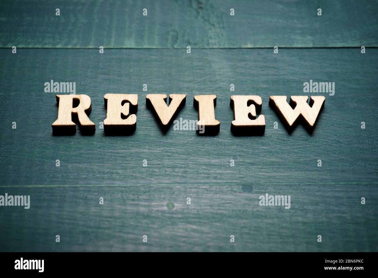 Review word on a wood table Stock Photo - Alamy