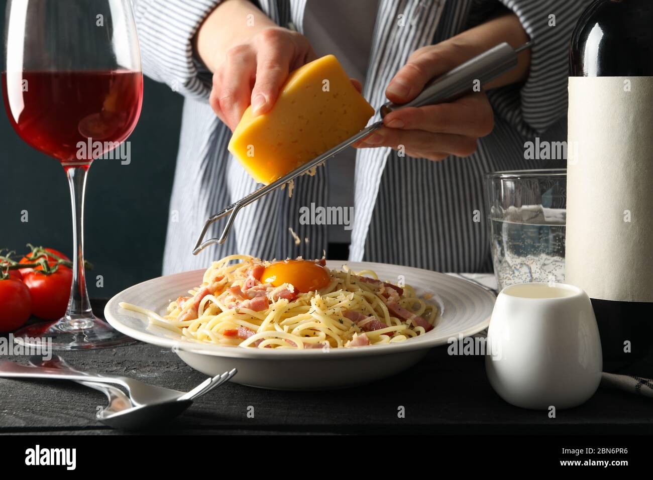 Woman grating cheese on pasta. Cooking pasta composition Stock Photo ...