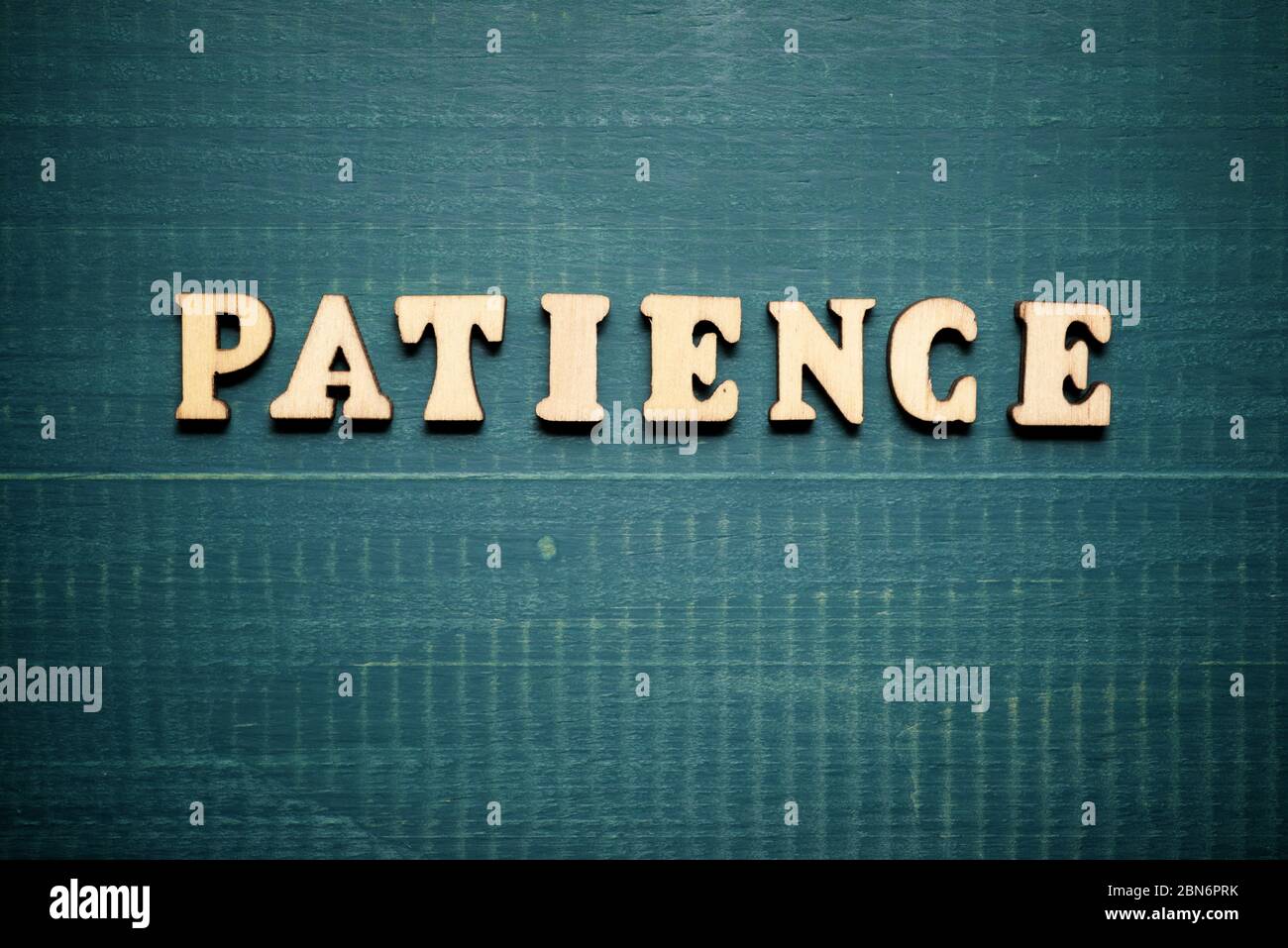 Patience word on a wood table Stock Photo - Alamy