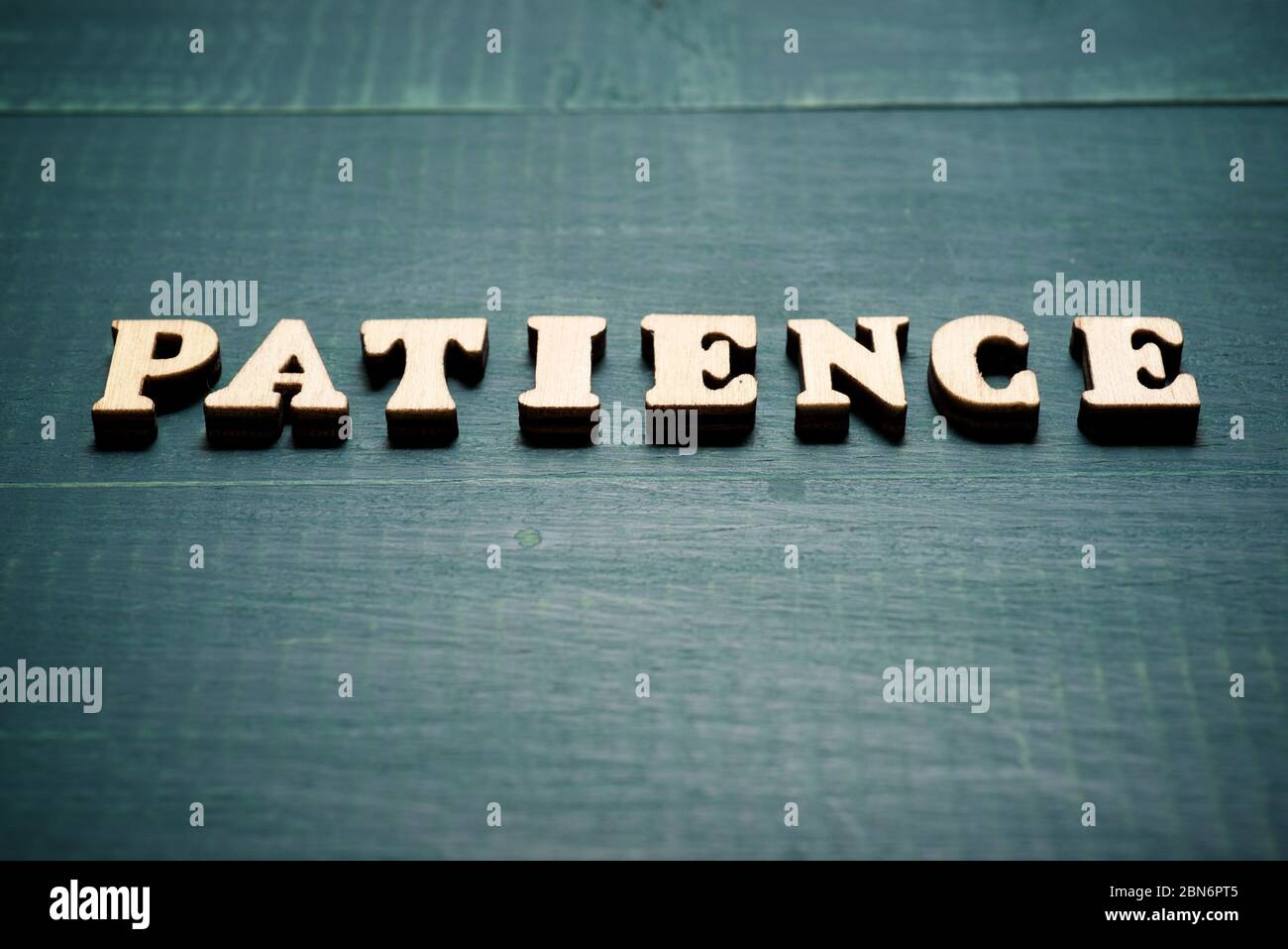 Patience word on a wood table Stock Photo - Alamy