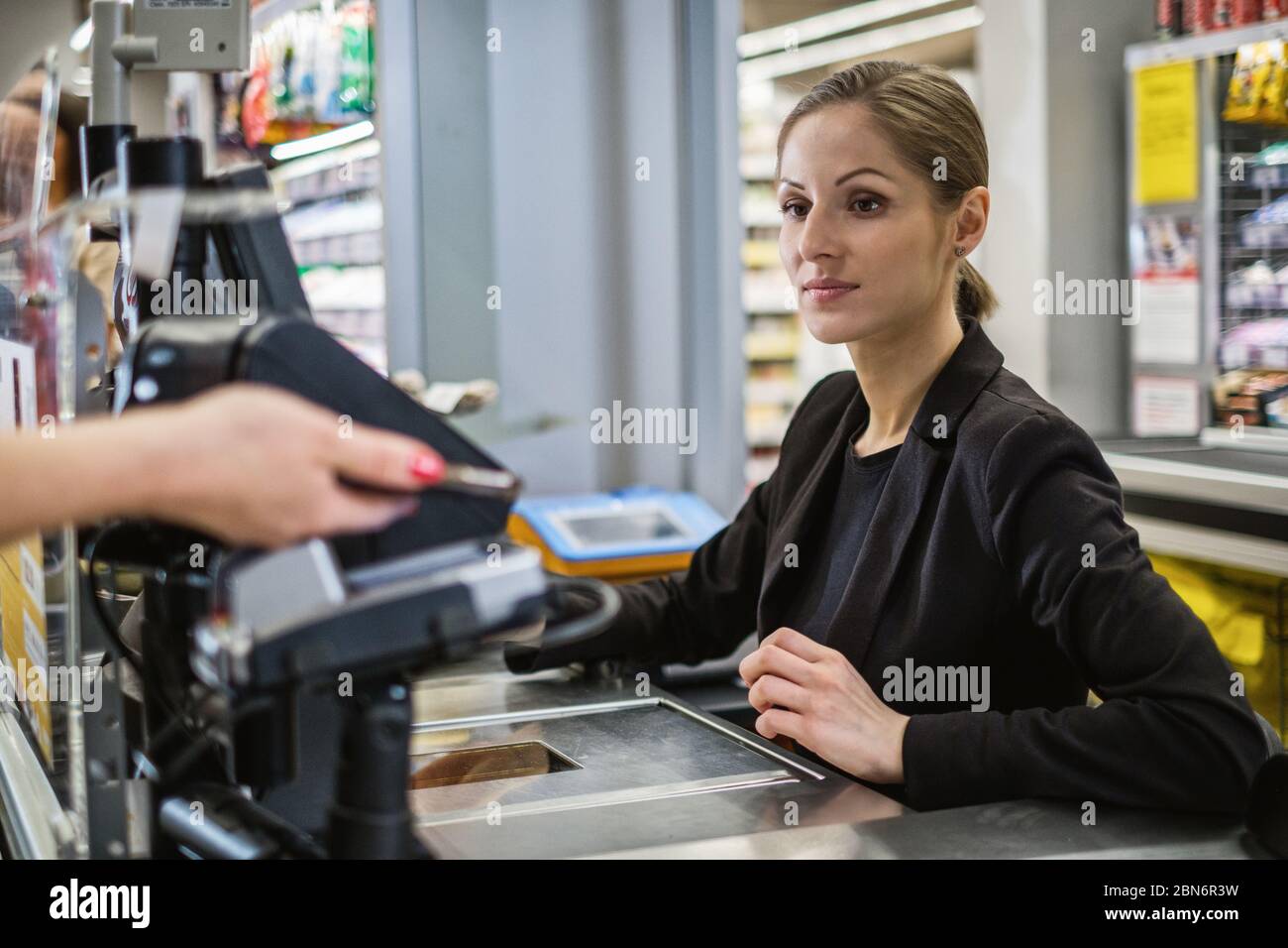 Paying with smart phone in a grocery store Stock Photo - Alamy