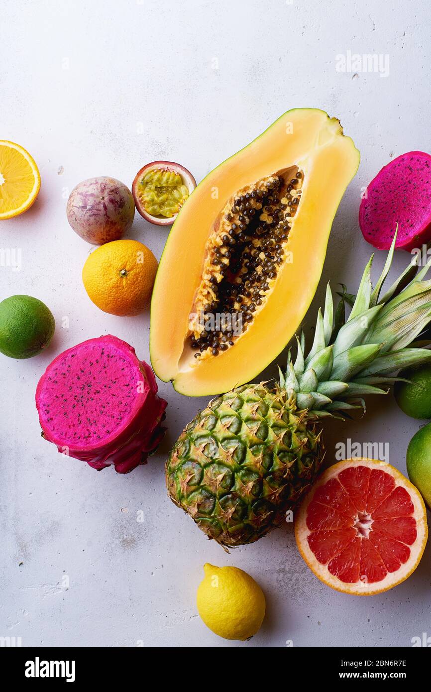 Tropical fruits flat lay with mango, papaya, pitahaya, passion fruit ...