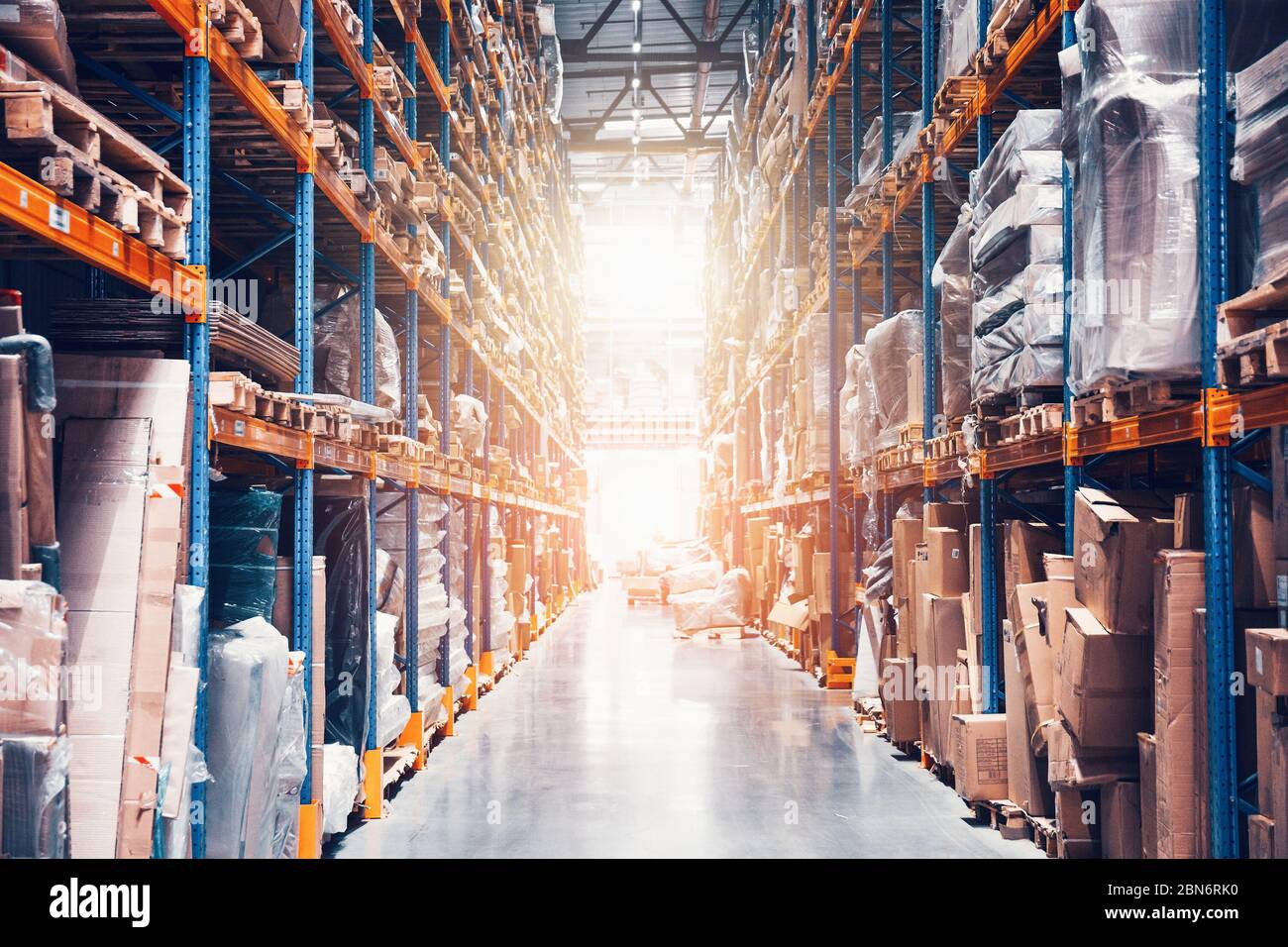 Large distribution warehouse with high shelves, many goods and boxes ...