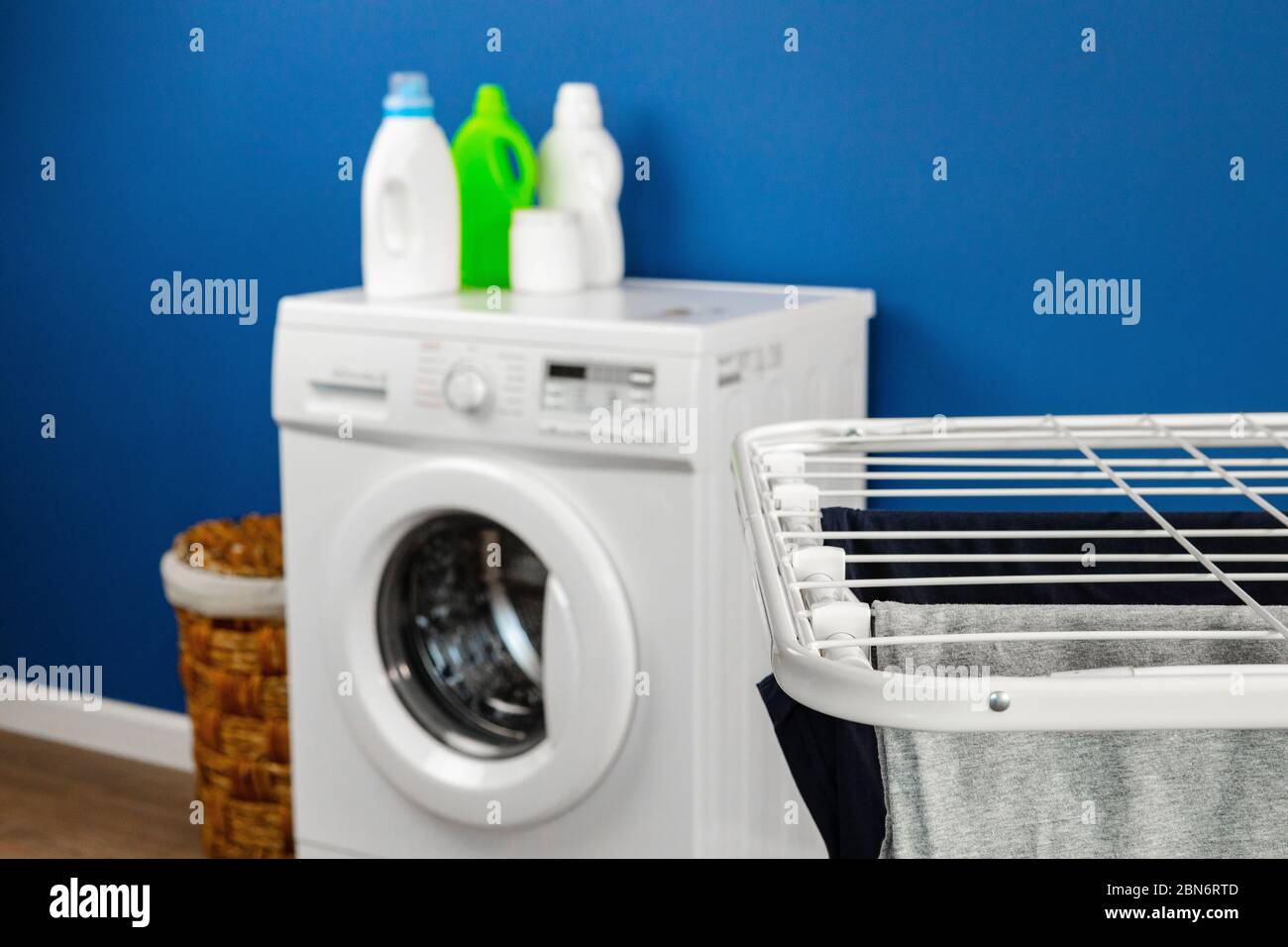 Laundry room interior with washing machine and clothes dryer near wall ...