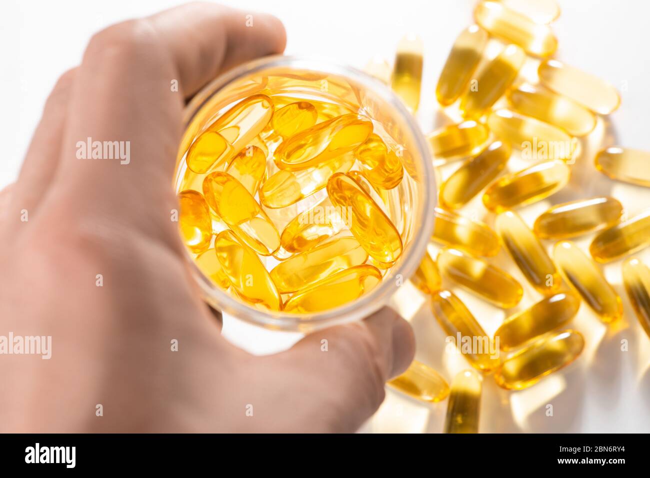 Cod liver oil capsules hand hi-res stock photography and images - Alamy