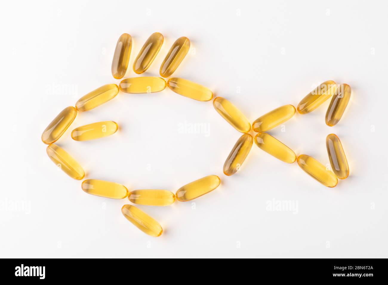 Fish shape made of cod liver oil capsules Stock Photo - Alamy