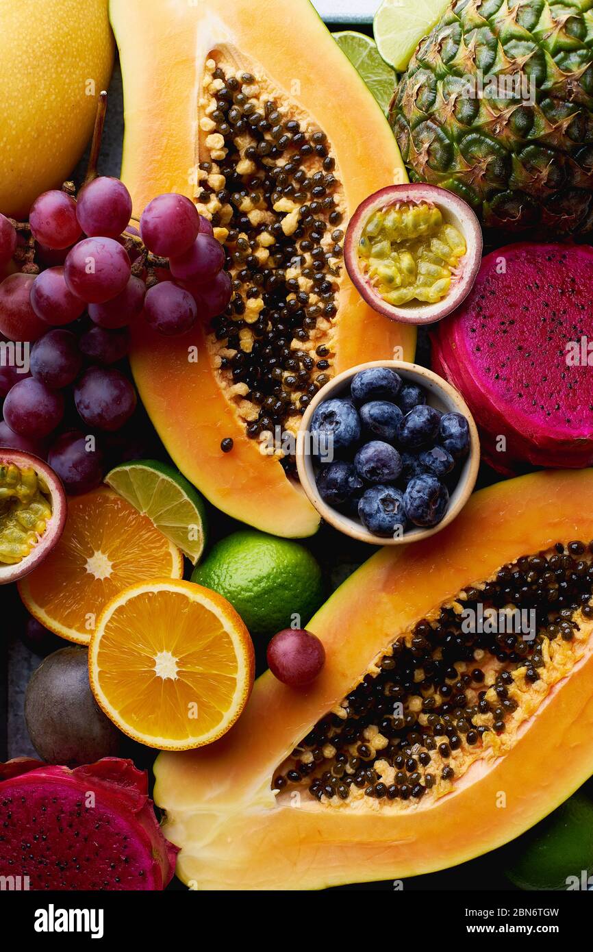 Tropical fruits flat lay with mango, papaya, pitahaya, passion fruit ...