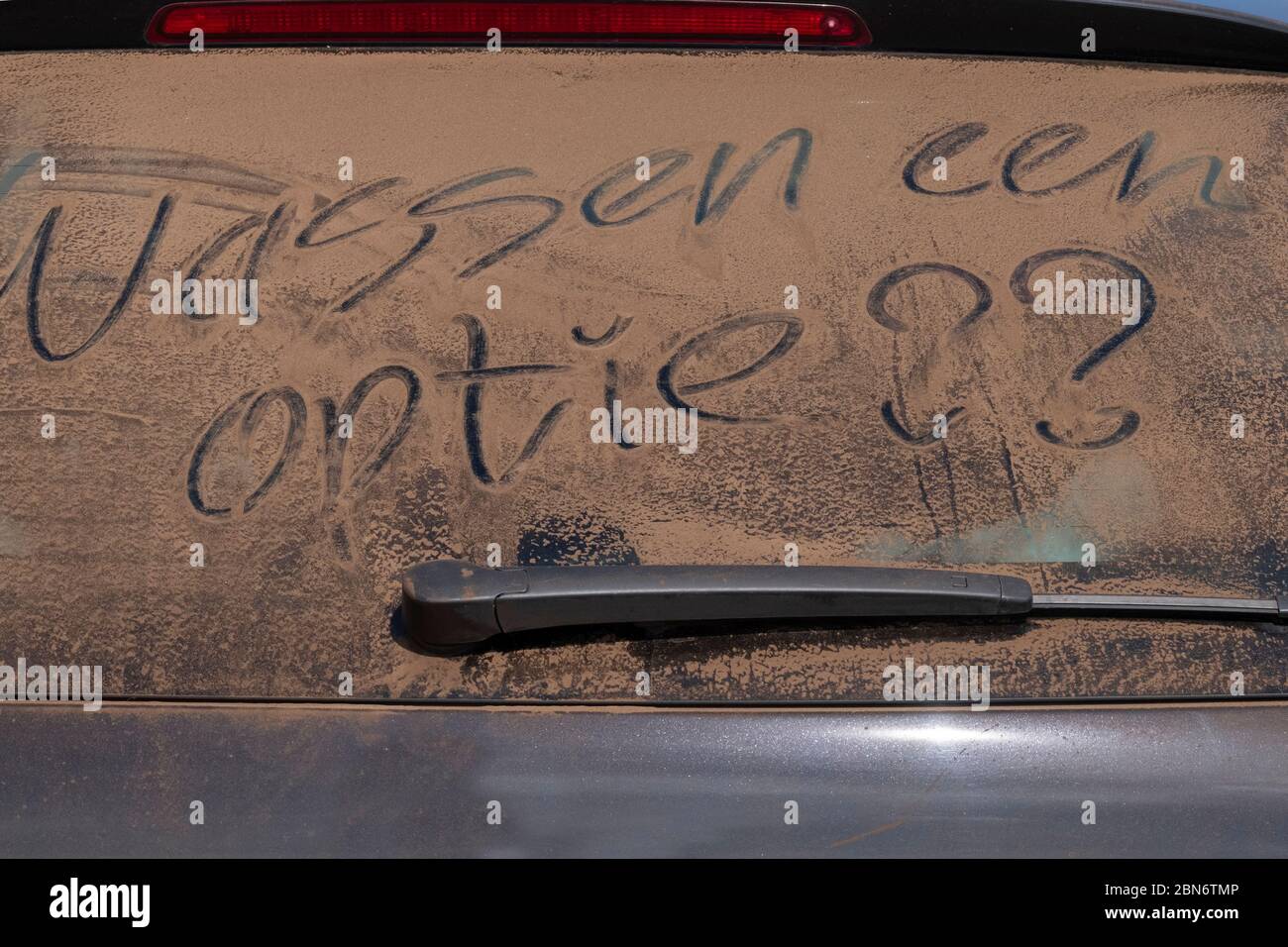 Rear window of a car covered with sand. Dutch sense means: that the car ...