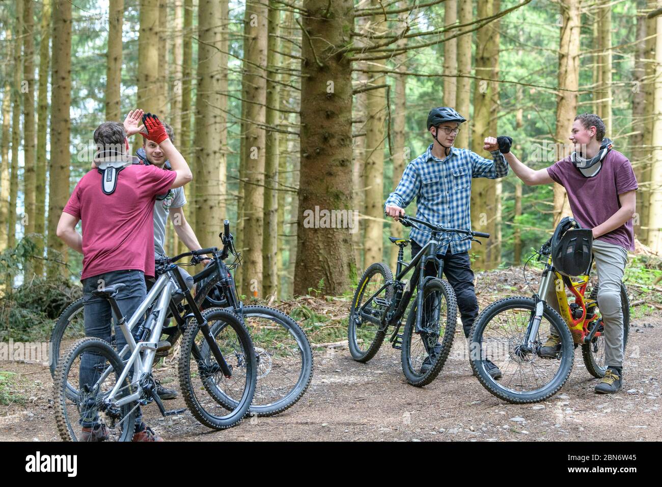 Two downill mountainbikers giving a high five to each other after ...