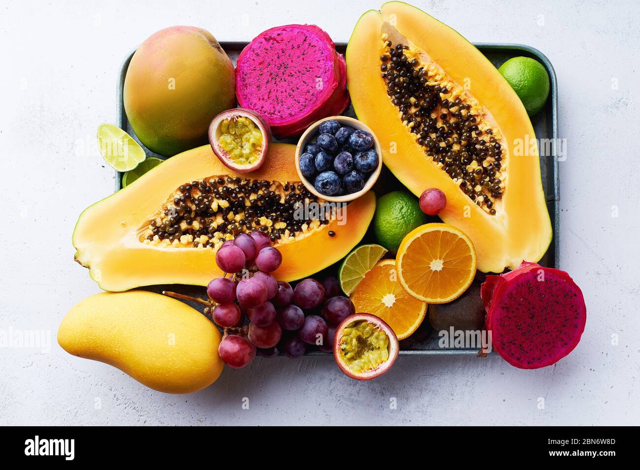 Tropical fruits flat lay with mango, papaya, pitahaya, passion fruit ...