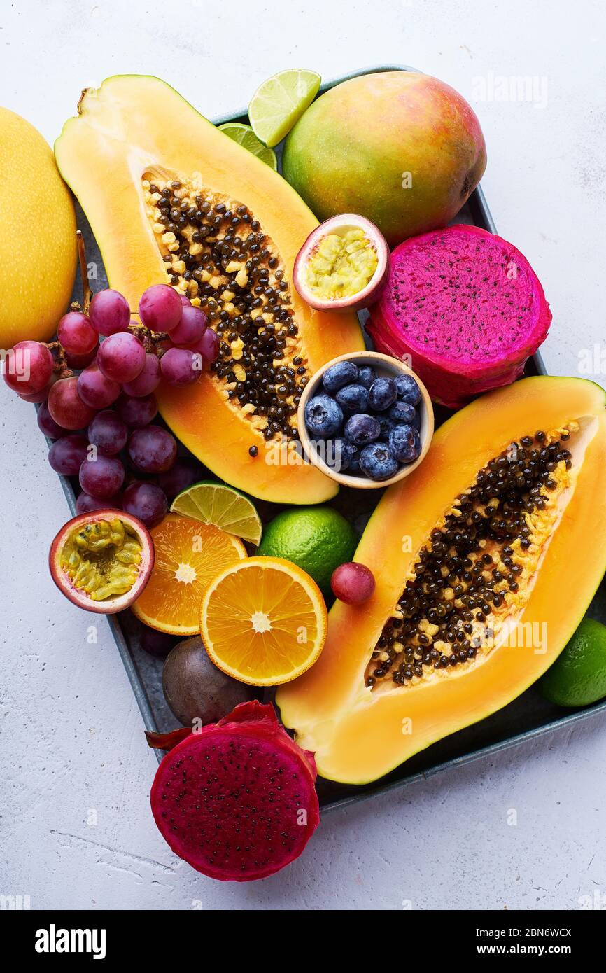 Tropical fruits flat lay with mango, papaya, pitahaya, passion fruit ...