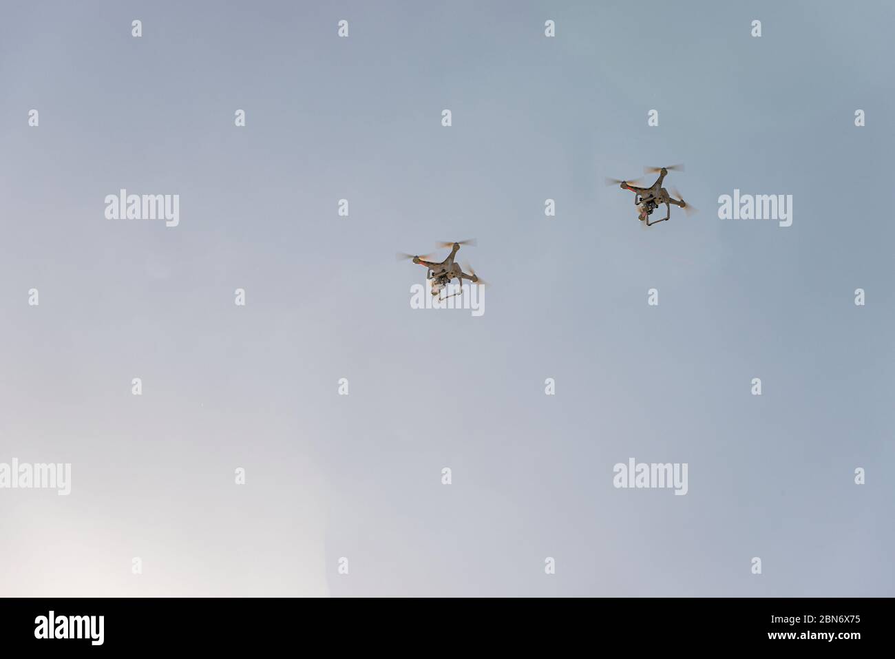 two identical drones flying side by side in the air Stock Photo - Alamy