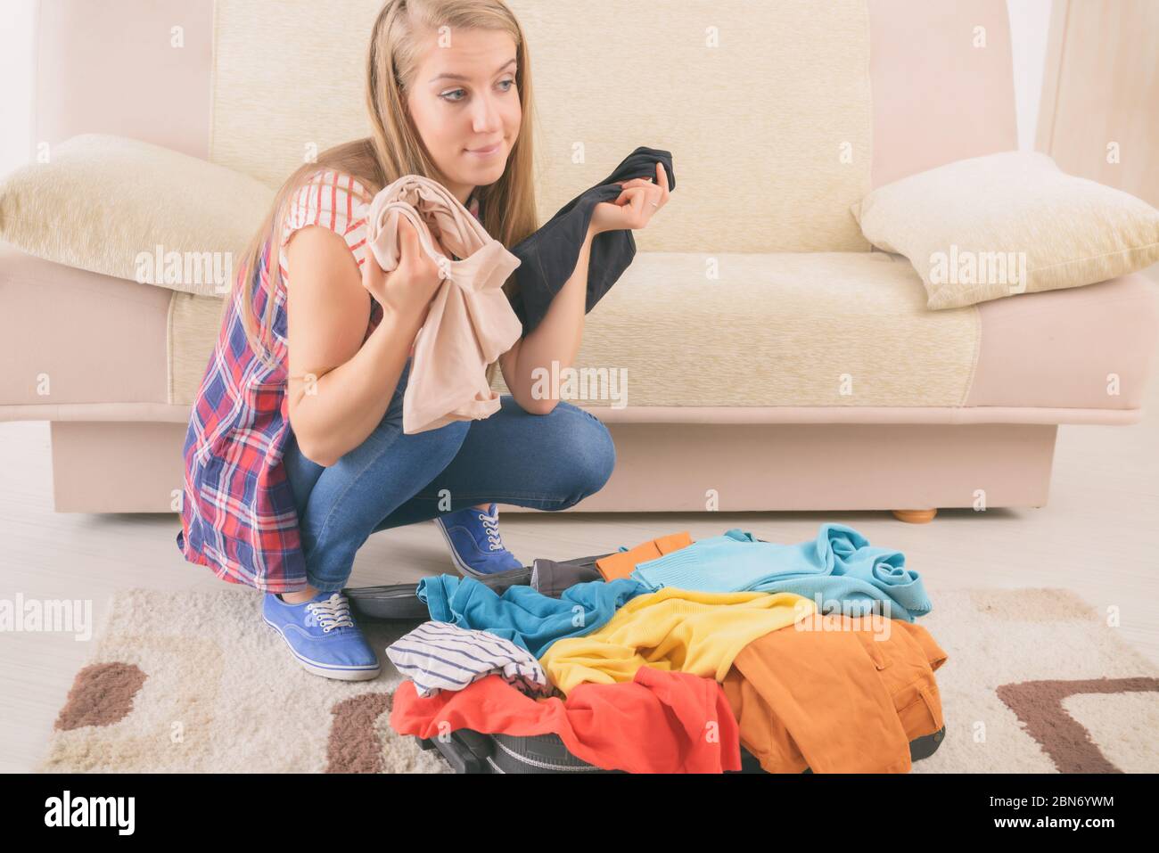 Young girl packing a suitcase for a holiday trip Stock Photo - Alamy