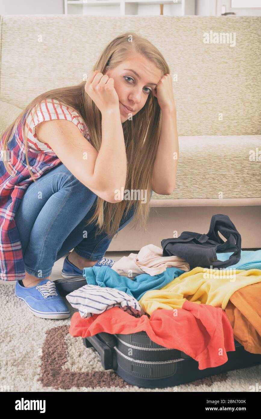Girl packing suitcase hi-res stock photography and images - Alamy