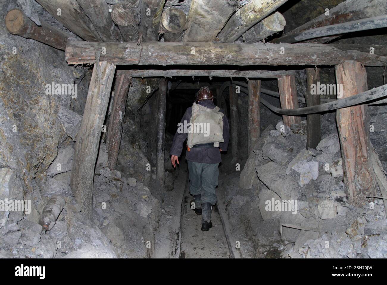 A miner walks through a dangerously unstable shaft of a mine in Cerro ...