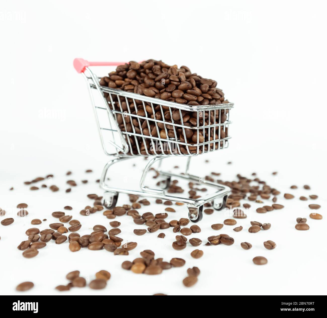 Coffee beans inside small shopping cart on white background Stock Photo ...