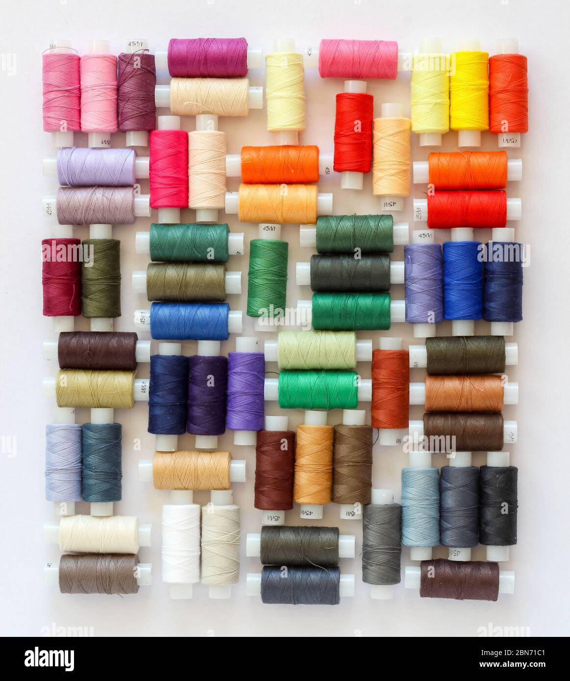 Creative arrangement of colorful threads on a white background Stock ...