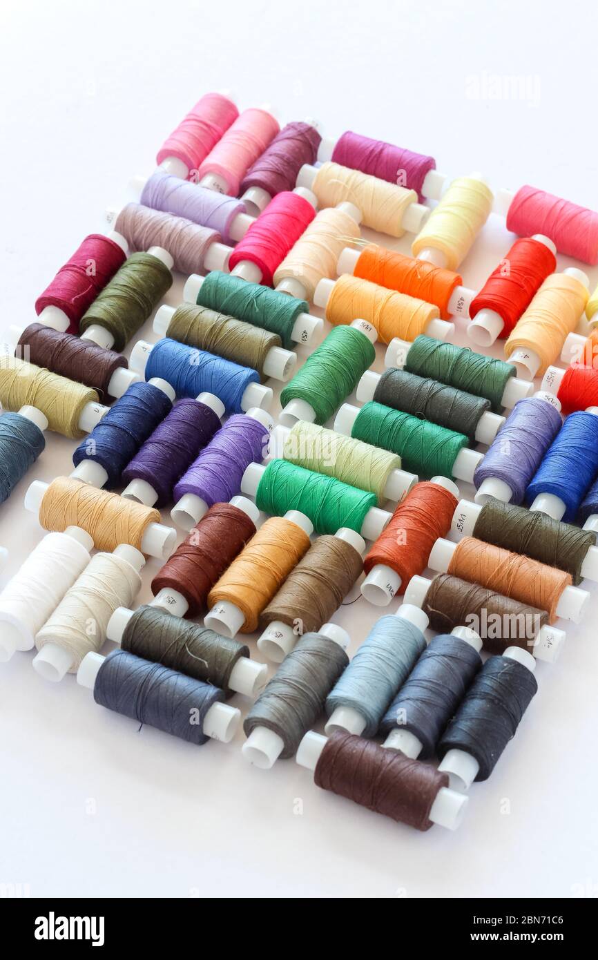 Creative arrangement of colorful threads on a white background Stock ...