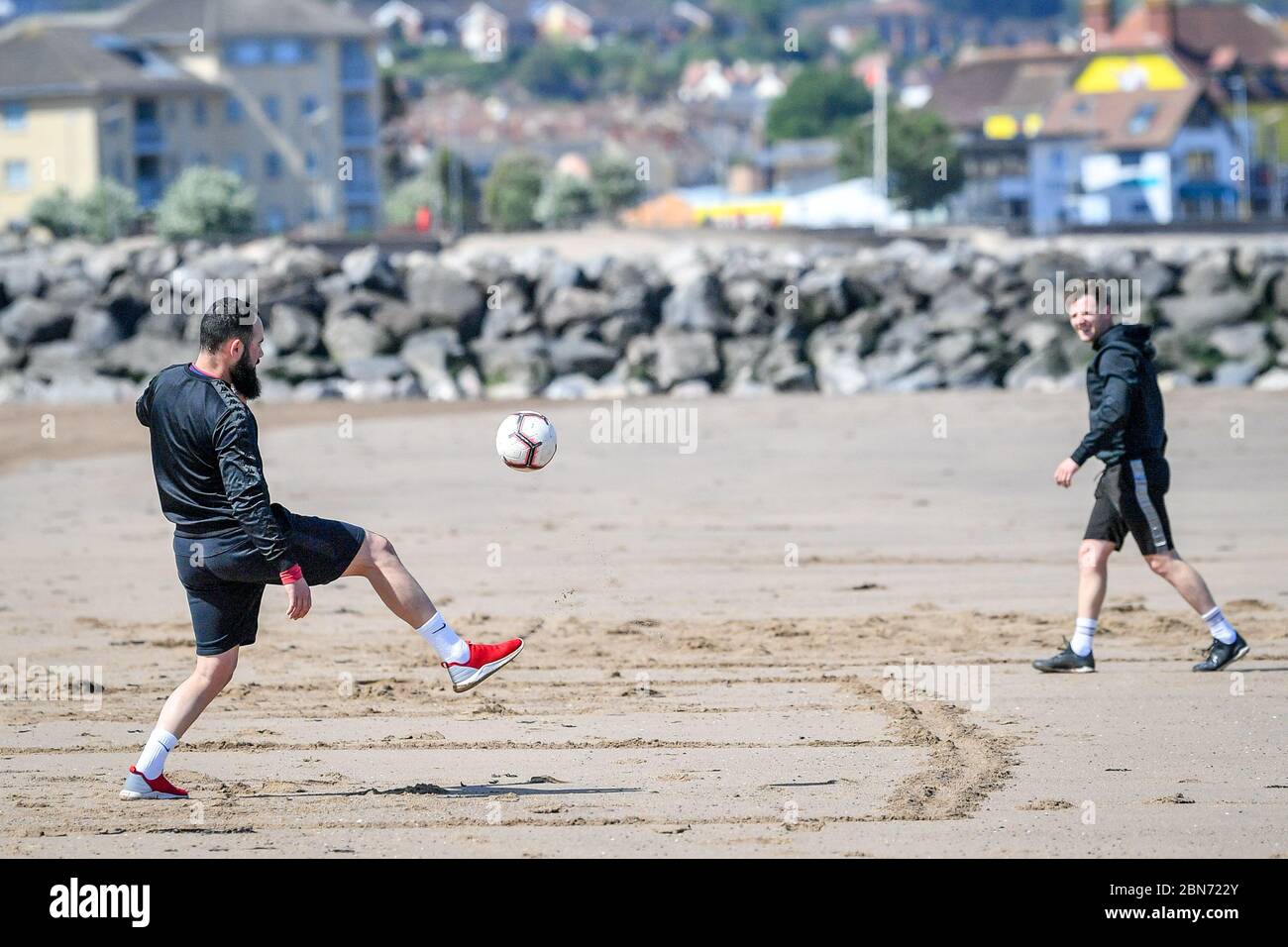 Two men play football on the beach at Minehead after the announcement ...