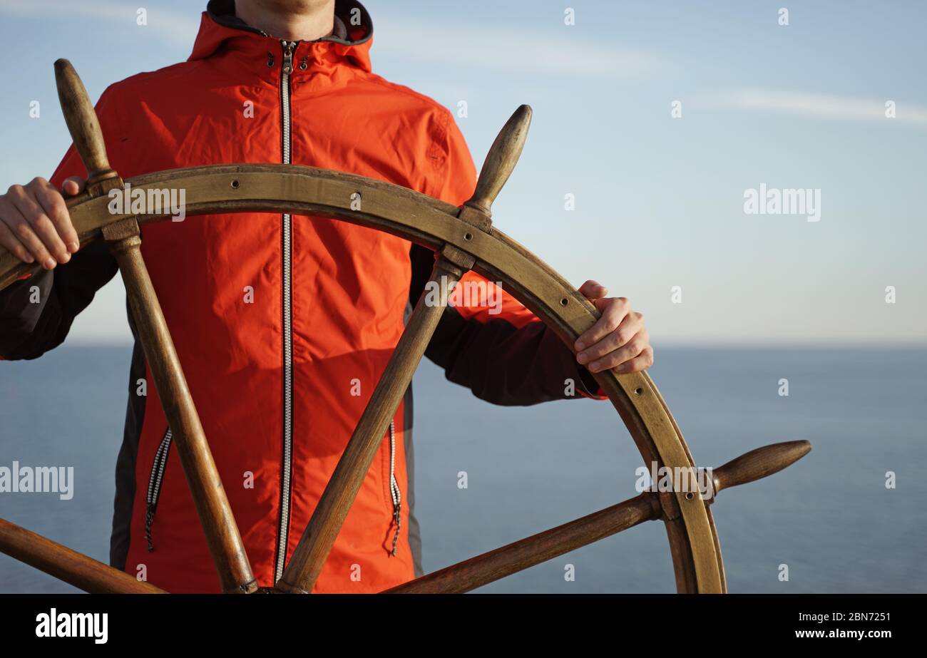 Man holding ship rudder Stock Photo - Alamy
