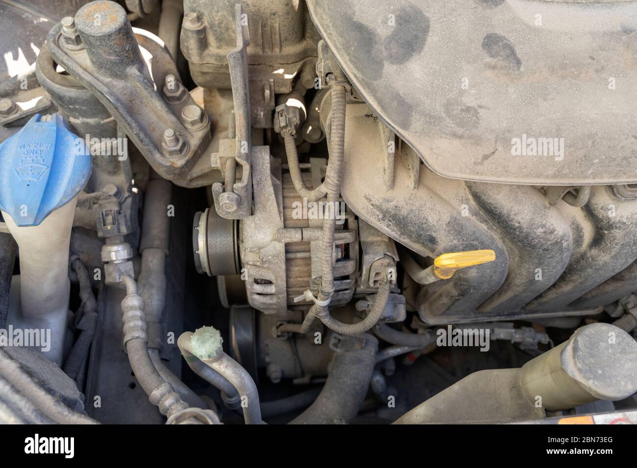 Auto mechanic works in the garage. Repair. Car generator Stock Photo ...
