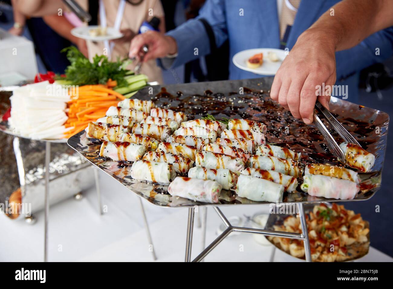 men in blue suits choosing food at a banquet Stock Photo - Alamy