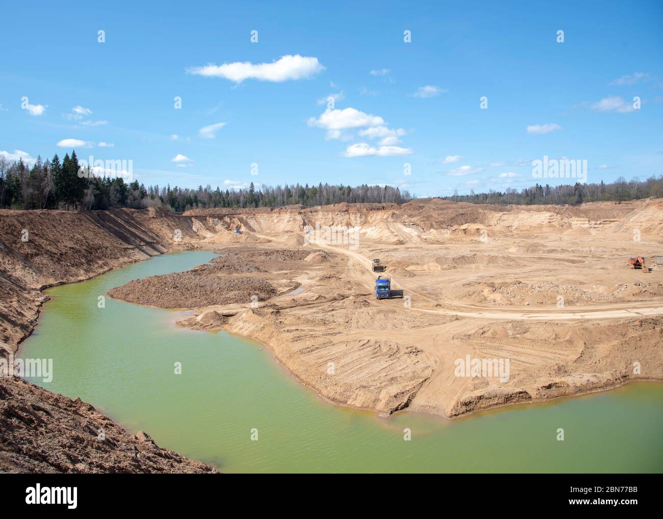 Sand deep quarry under a blue cloudy sky Stock Photo - Alamy