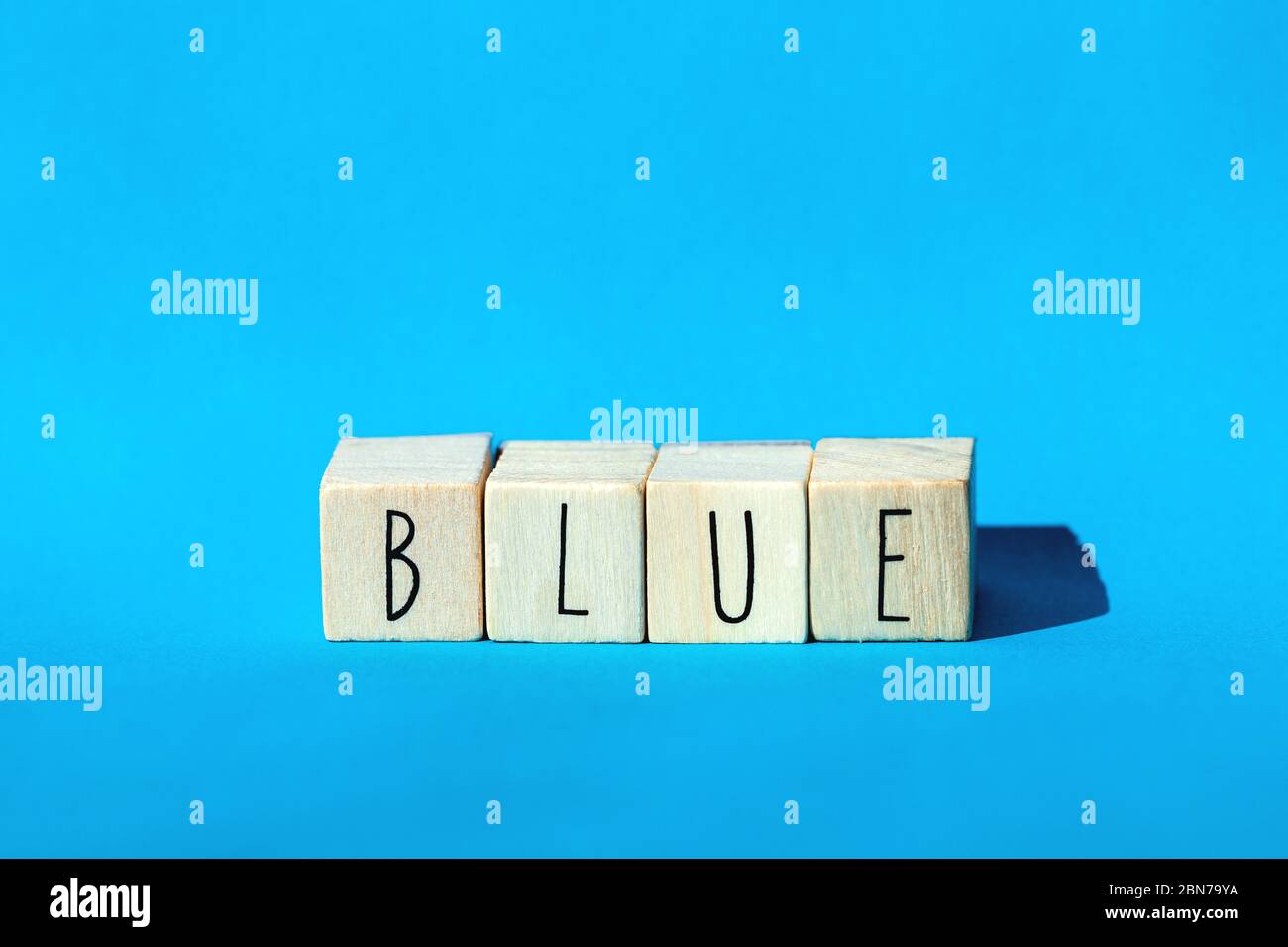 Wooden cubes with the word Blue with blue background, colorful concept ...