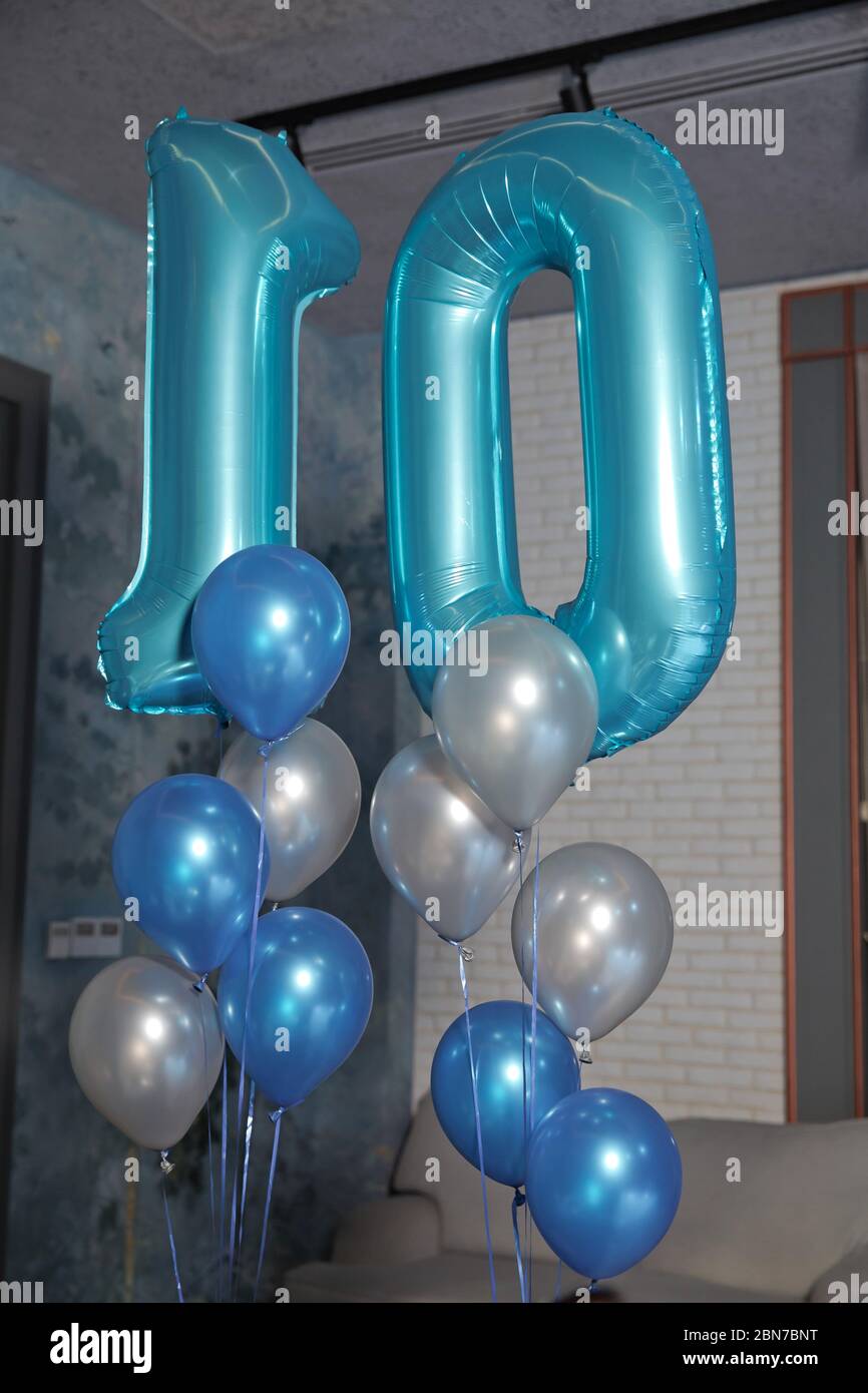 Ten-year-old blue balloon. White and blue balloons. Word 10 written ...