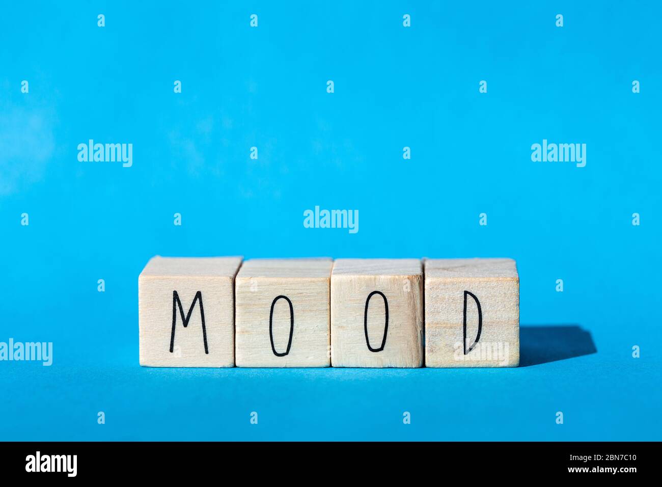 Wooden cubes with the word Mood with blue background, emotion concept ...