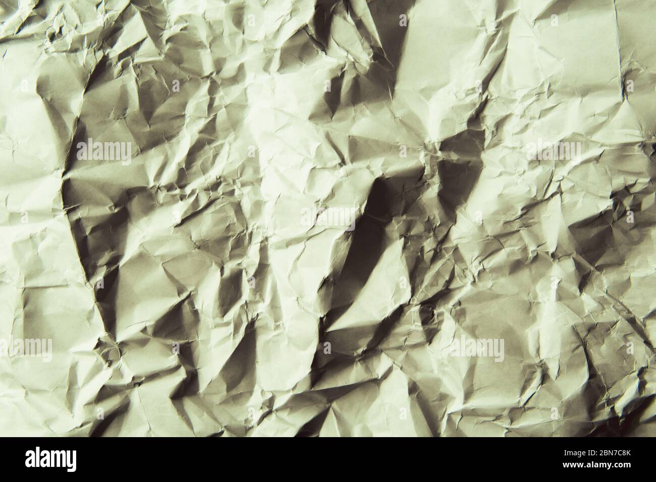 A crumpled paper background. Light green color Stock Photo - Alamy
