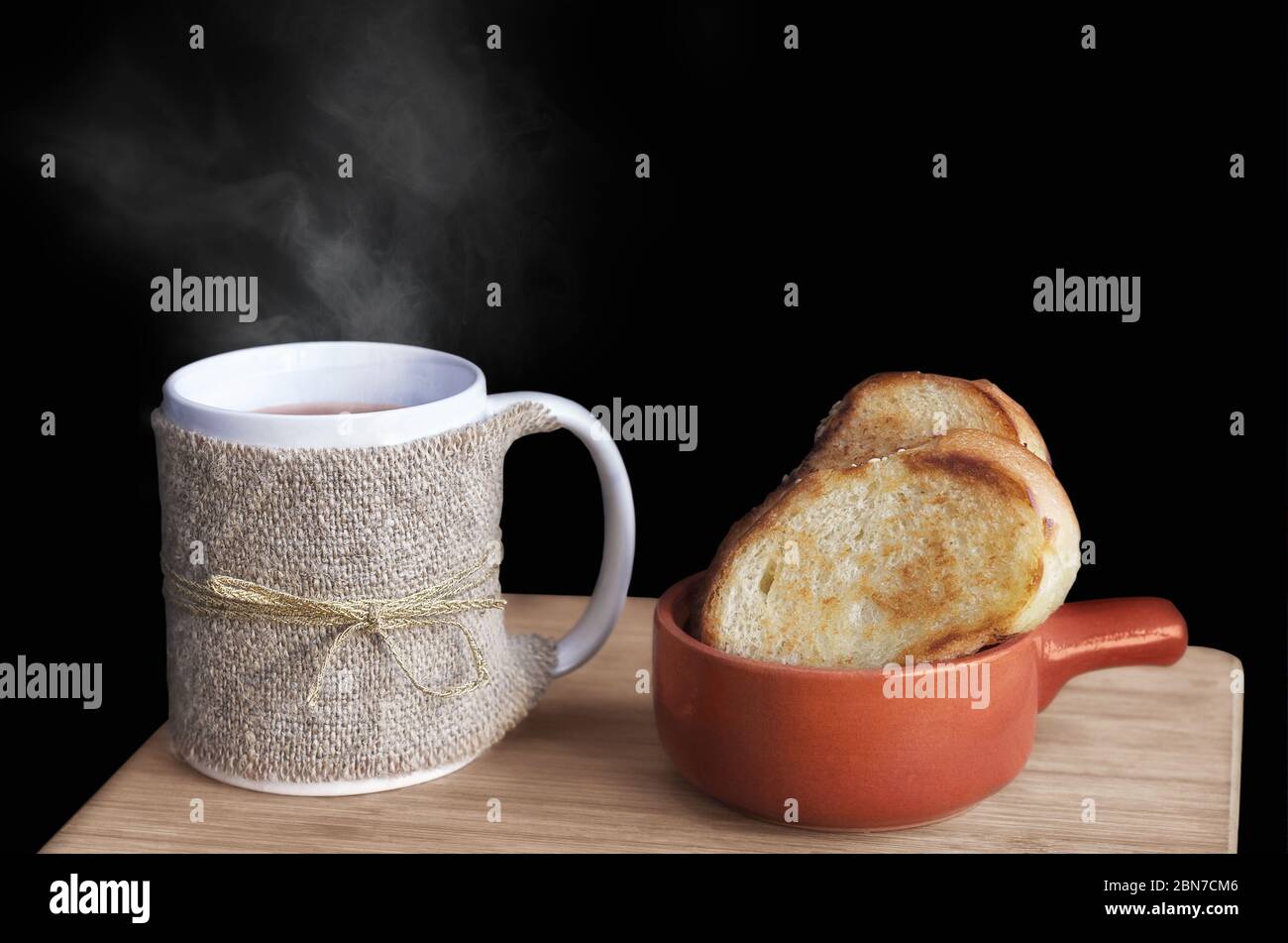 Steaming traditional black coffee in a mug and white bread toast Stock ...