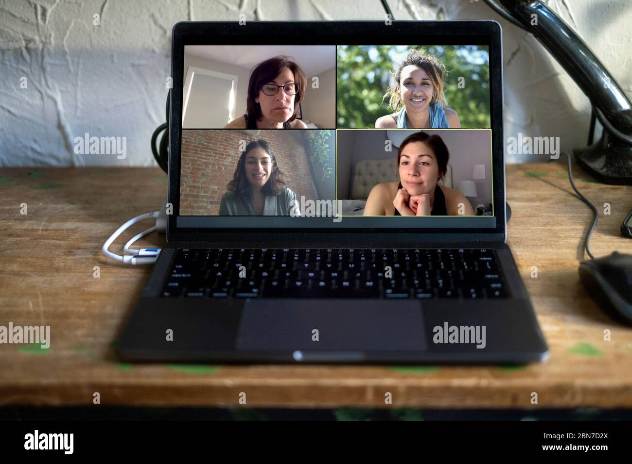 People having a virtual call online. Laptop on desk at home. Friends ...